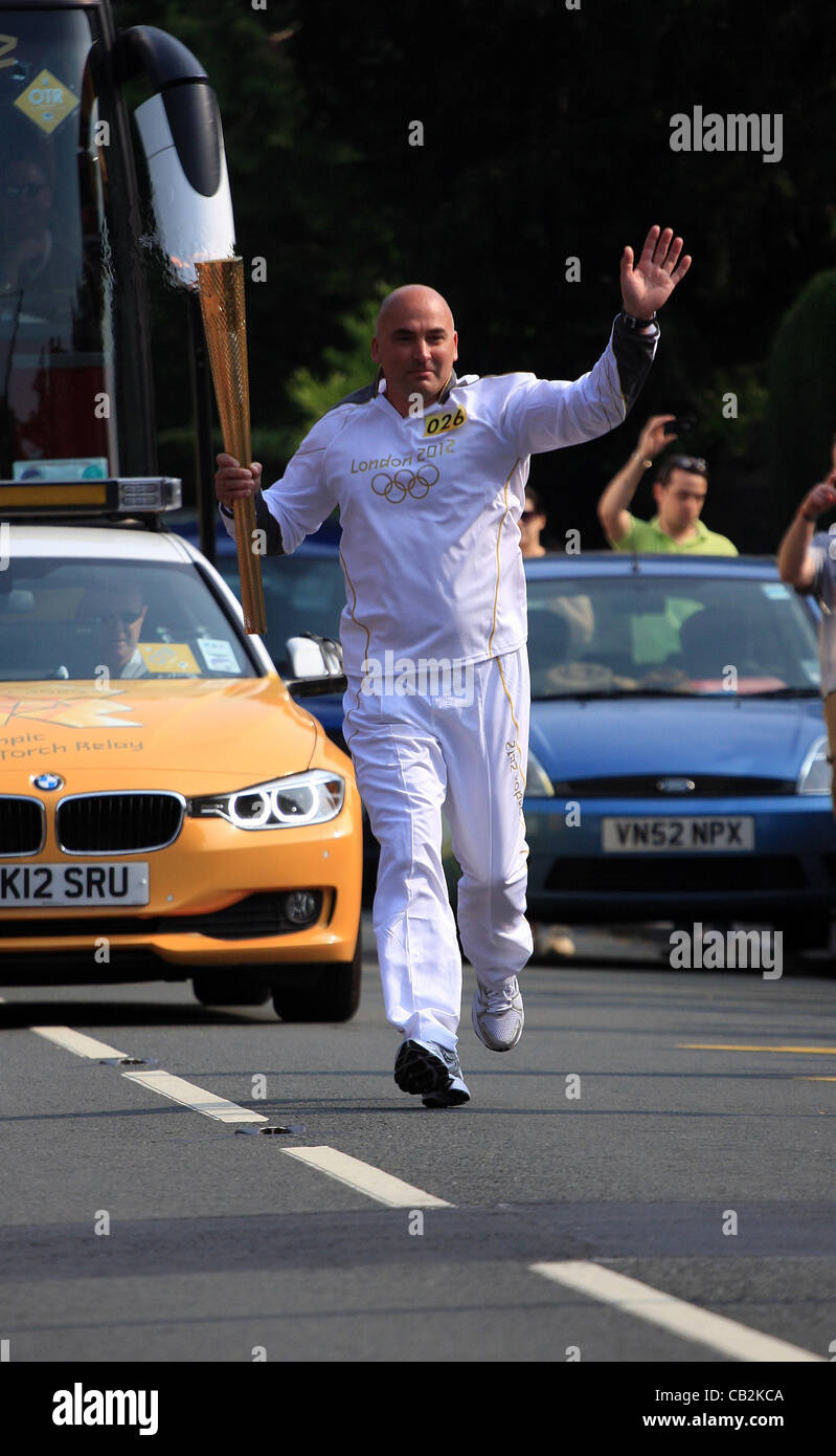 Rick Evans runs the Olympic Torch through Malvern Wells Worcestershire ...