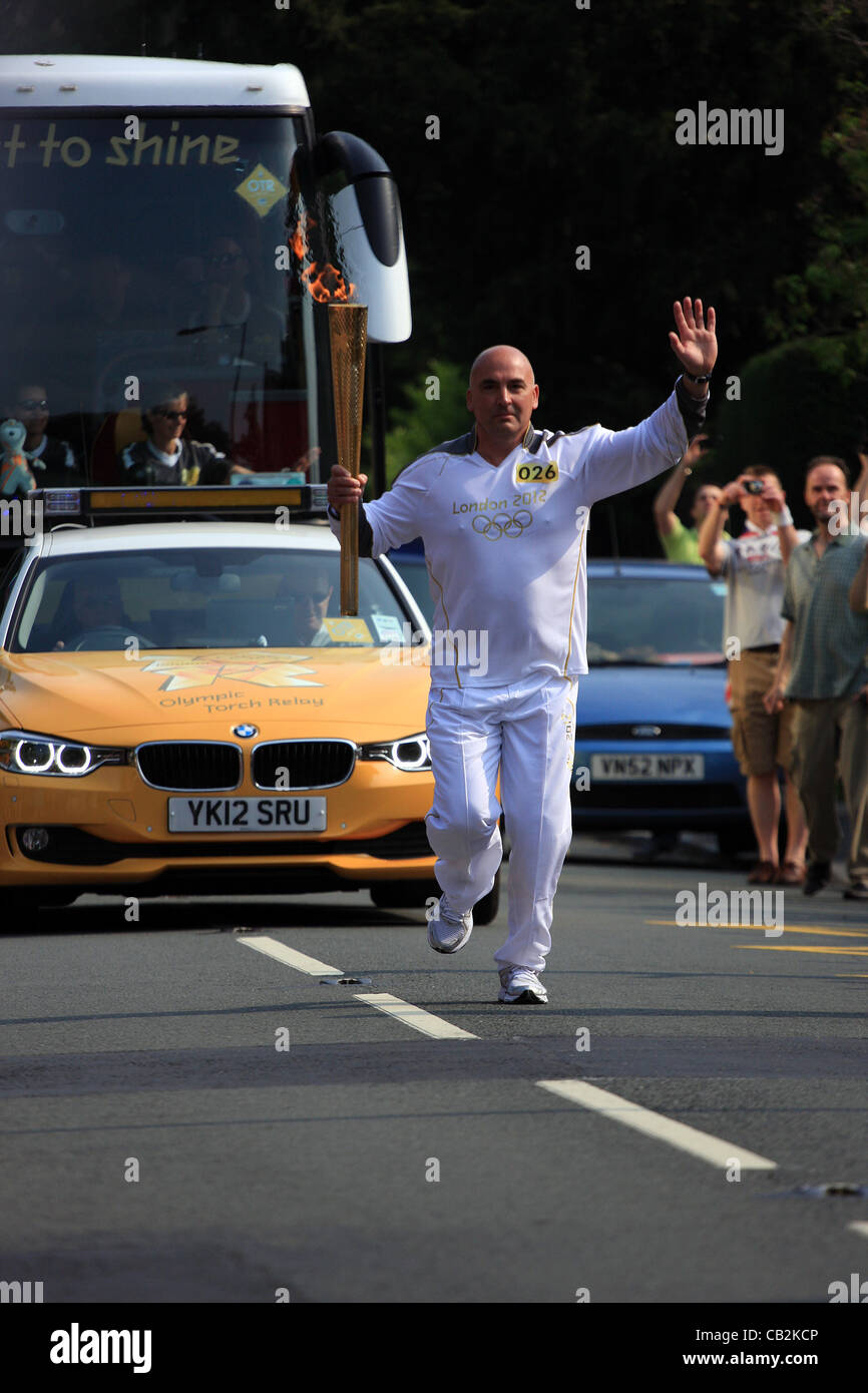 Rick Evans runs the Olympic Torch through Malvern Wells Worcestershire ...