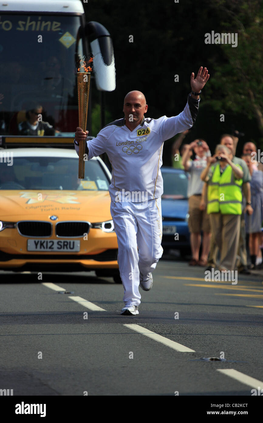 Rick Evans runs the Olympic Torch through Malvern Wells Worcestershire ...