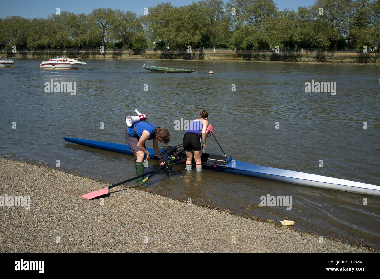 25 May, 2012. Putney London, UK. Two Female rowers carry a rowing boat ...