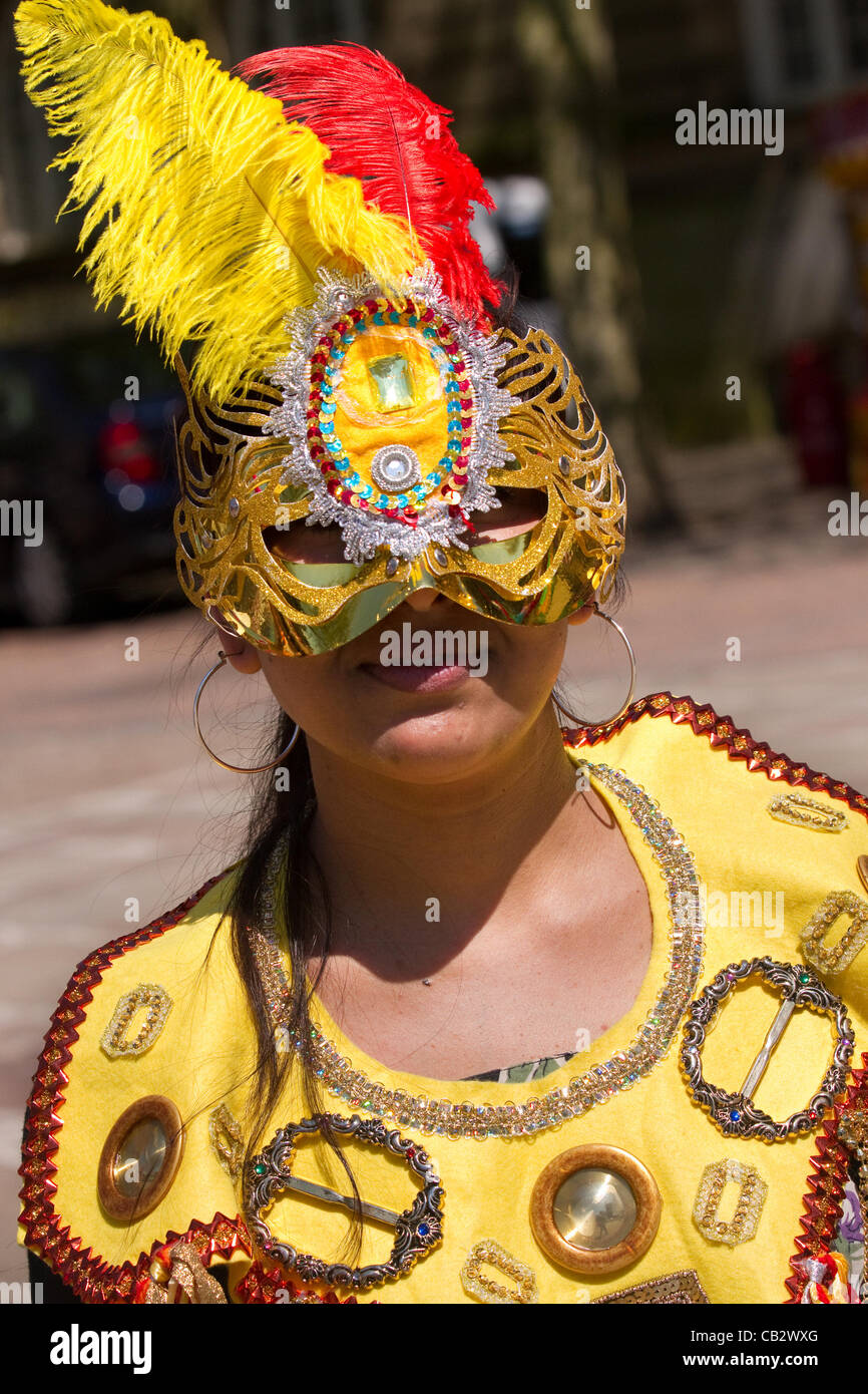 Dancers and Contestants wearing feathers & yellow face mask, at the ...