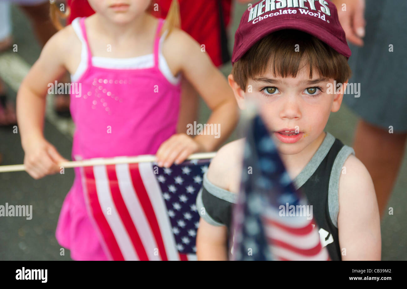 Young boy and girl holding American Flags while watching the Merrick ...