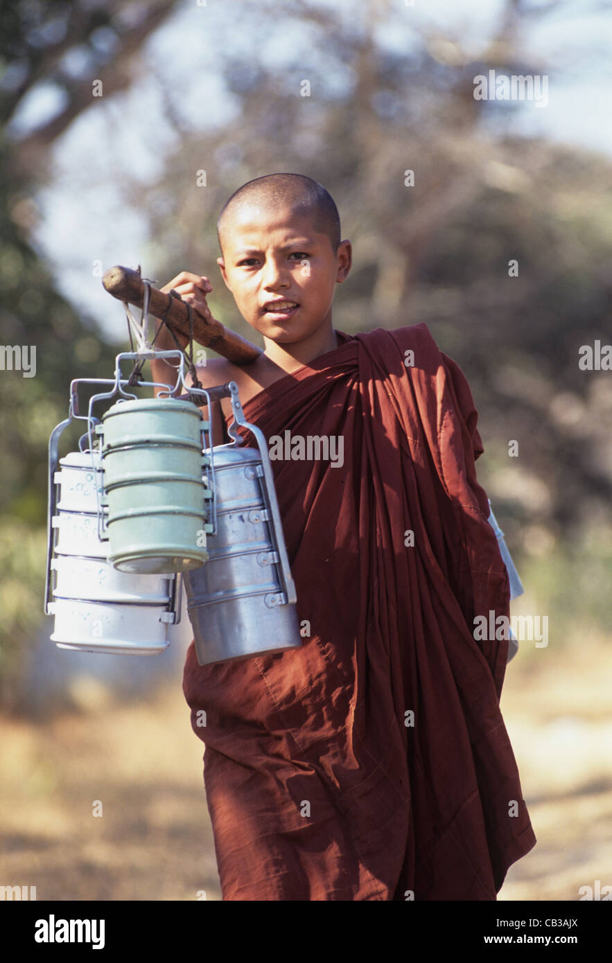 Young Buddhist Monk walking road with lunch boxes for alms, Magwe ...