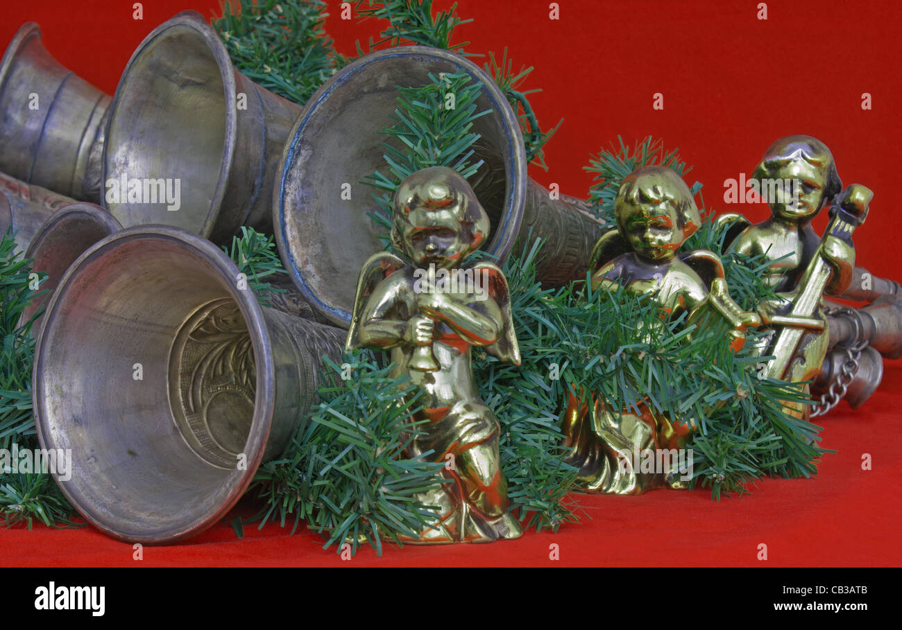 Golden angels playing musical instruments on red background Stock Photo ...