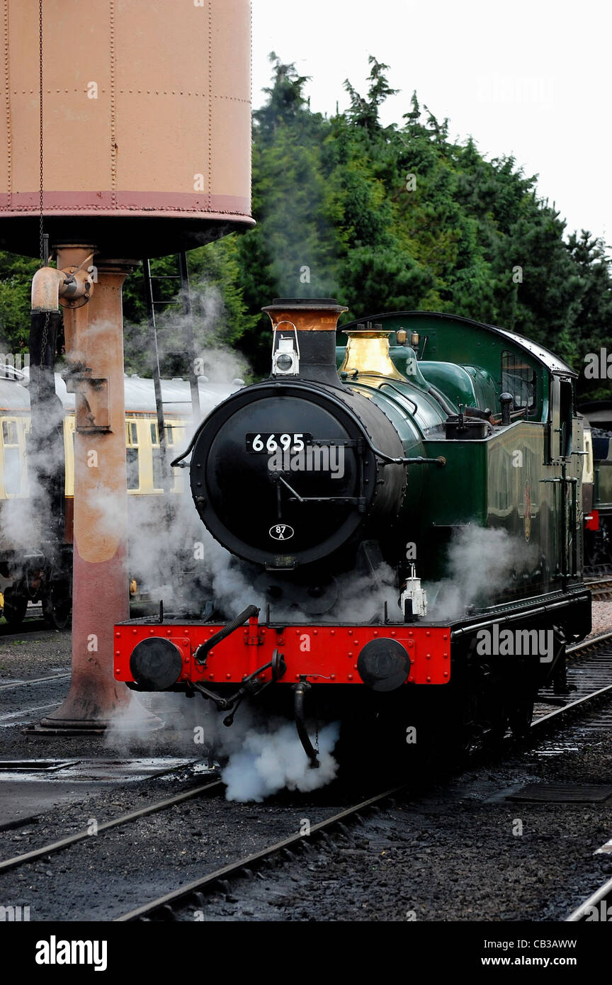 Steam locomotive beside water tank Stock Photo - Alamy