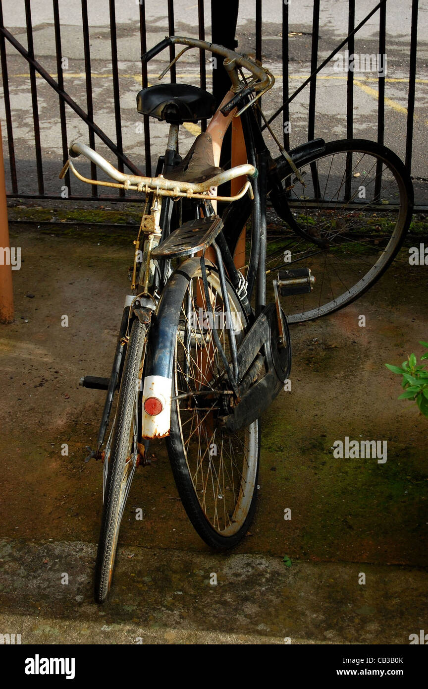 Two old style bicycles leaning against each other Stock Photo - Alamy