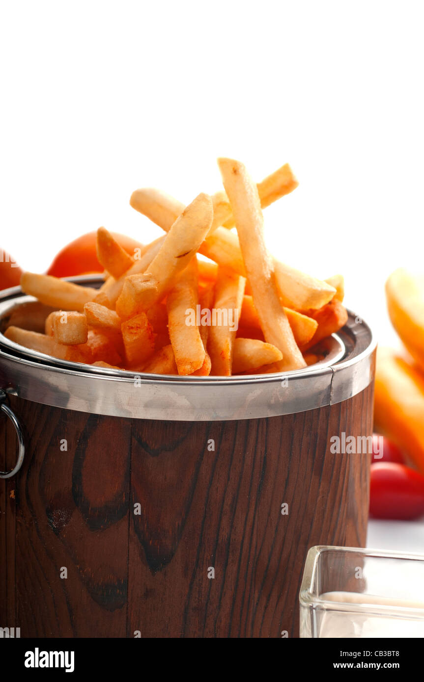 fresh french fries on a wood bucket with white dip sauce and fresh ...