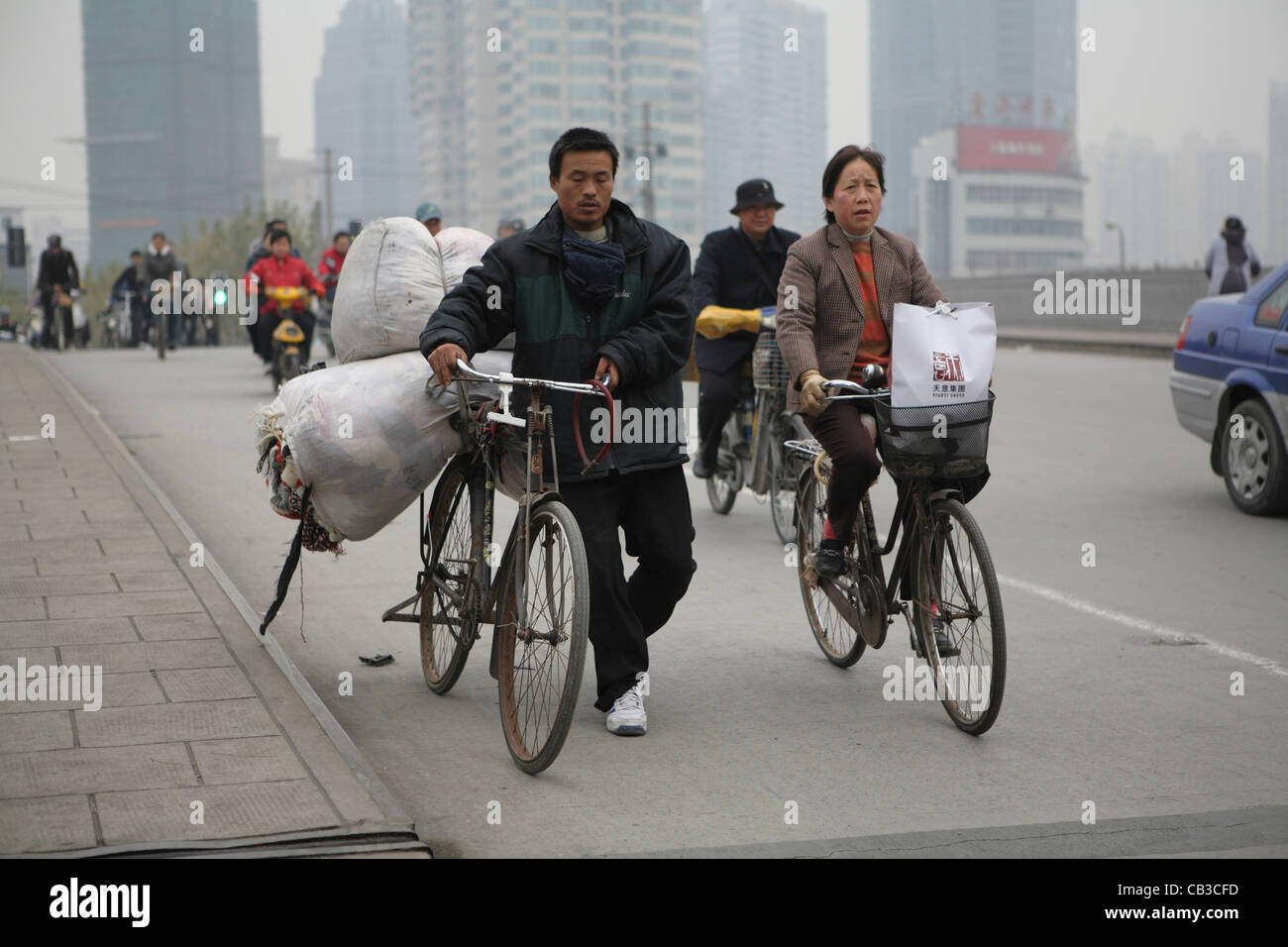 Chinese migrant workers crossing bridge in central Shanghai, China ...