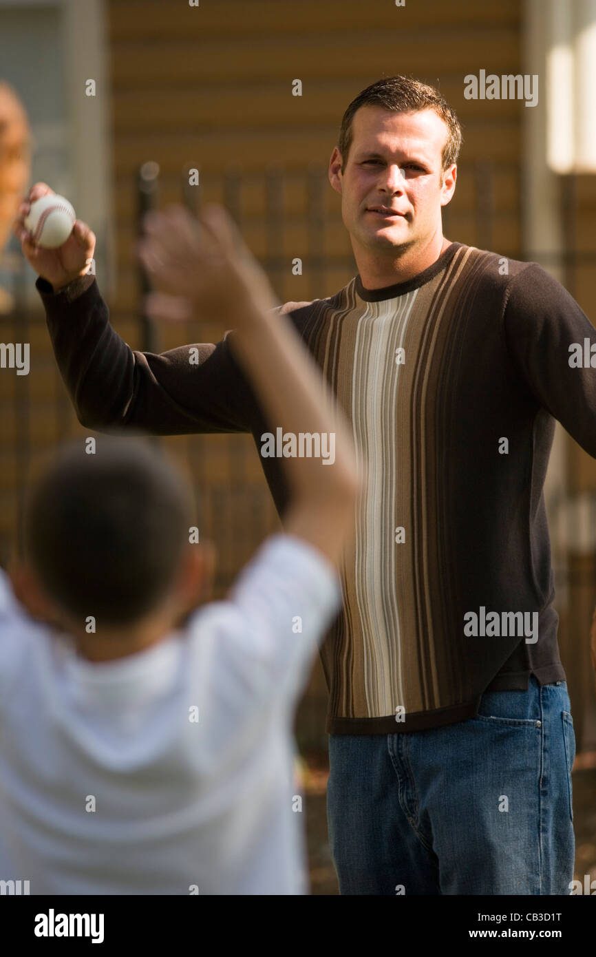 Father throwing a baseball to his son Stock Photo - Alamy