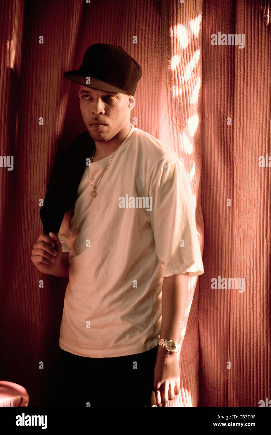 Portrait of young man in hip-hop fashion Stock Photo - Alamy