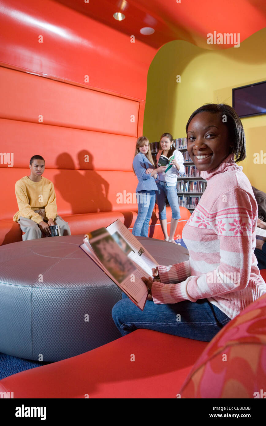 Teenagers hanging out in school library Stock Photo - Alamy