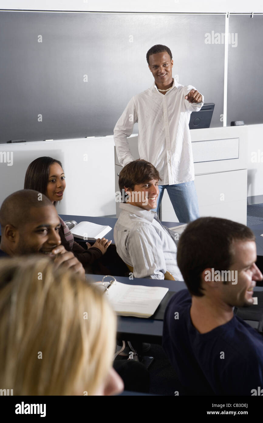 Teacher teaching students in the classroom Stock Photo - Alamy
