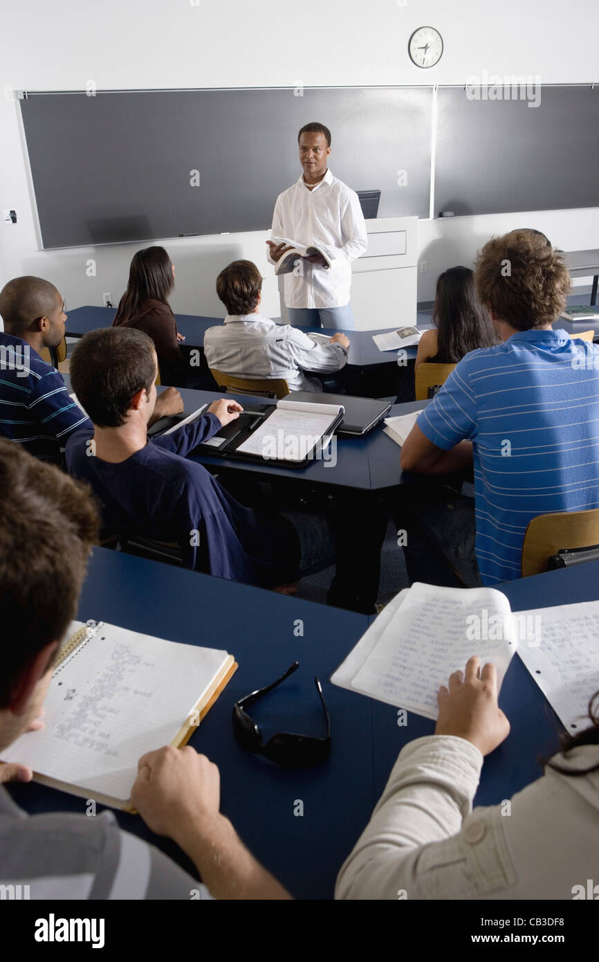 Teacher teaching students in the classroom Stock Photo - Alamy
