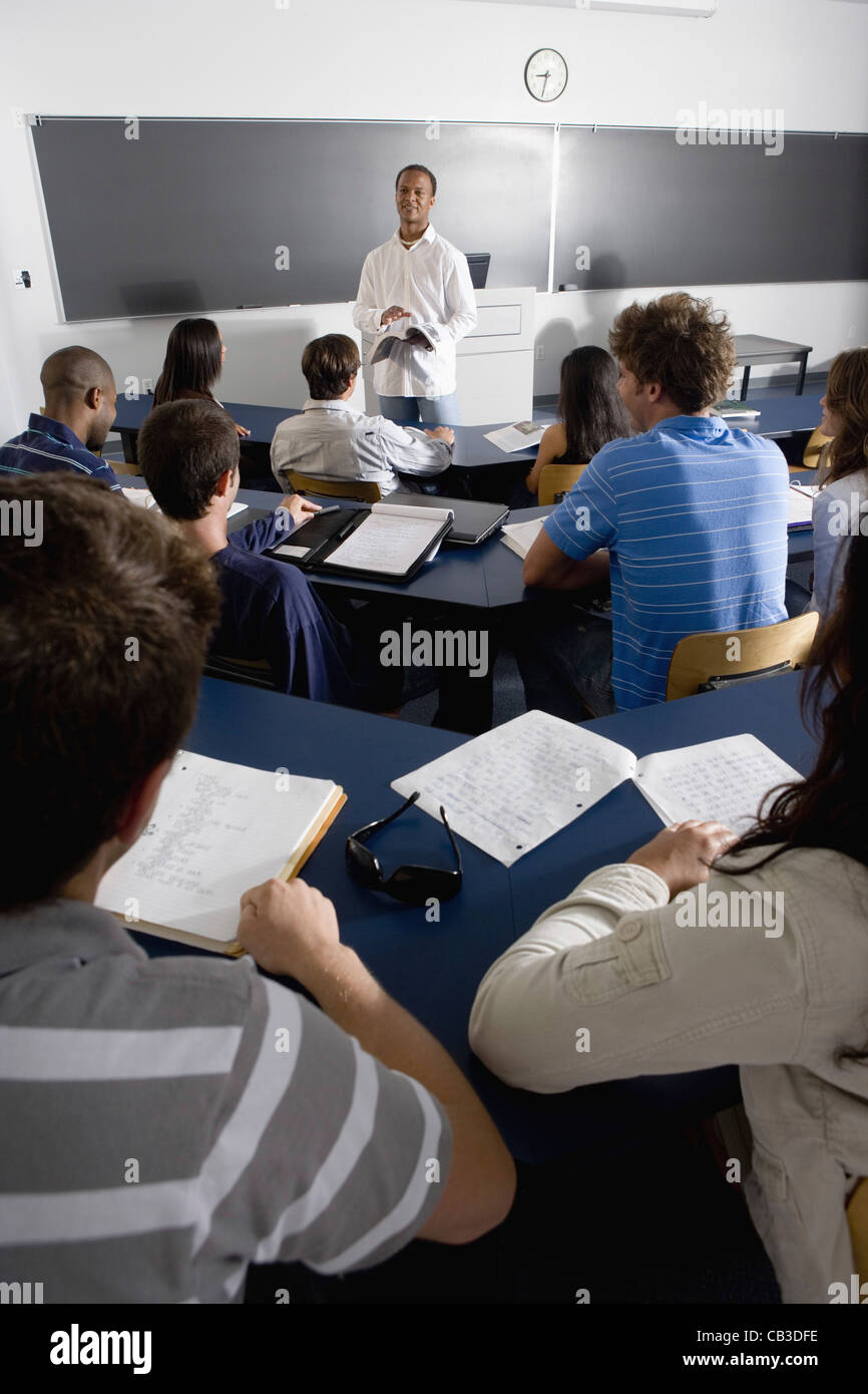Teacher teaching students in the classroom Stock Photo - Alamy