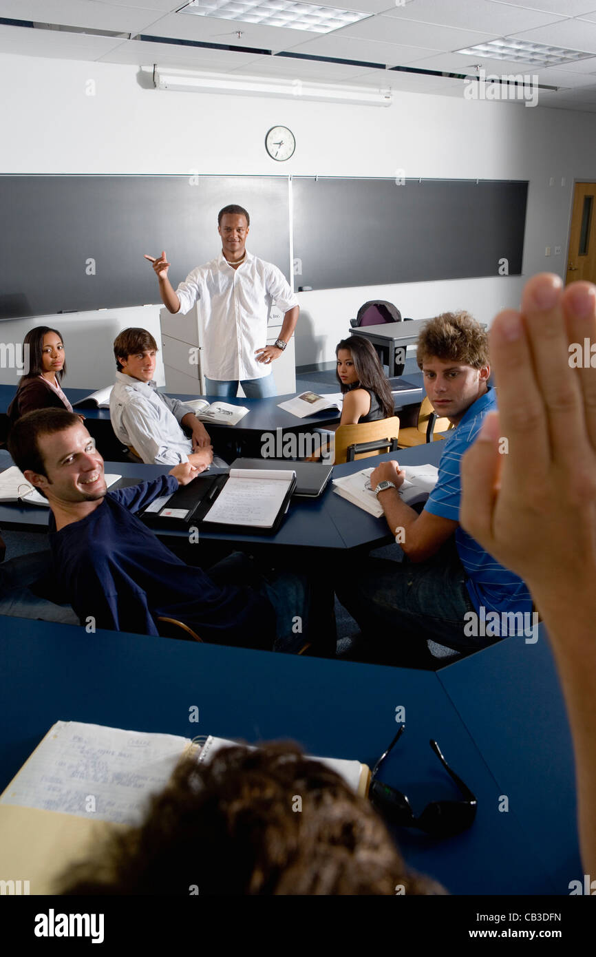 Teacher teaching students in the classroom Stock Photo - Alamy