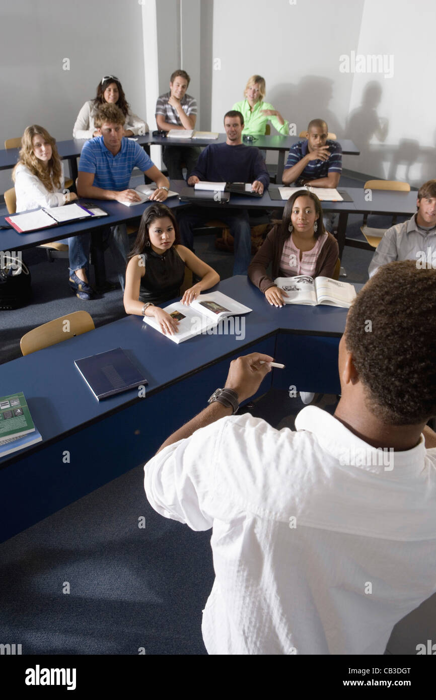 Teacher teaching students in the classroom Stock Photo - Alamy