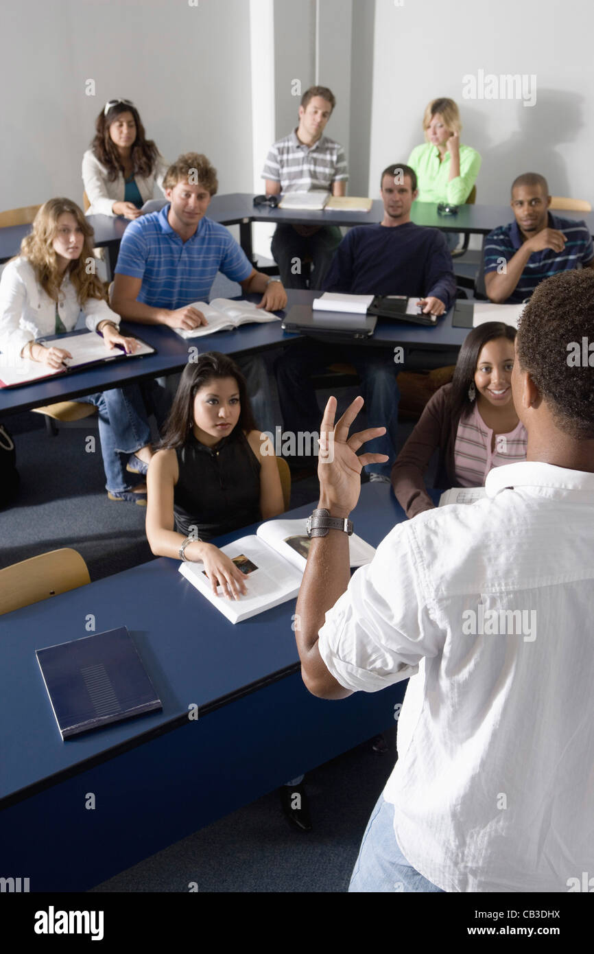 Teacher teaching students in the classroom Stock Photo - Alamy
