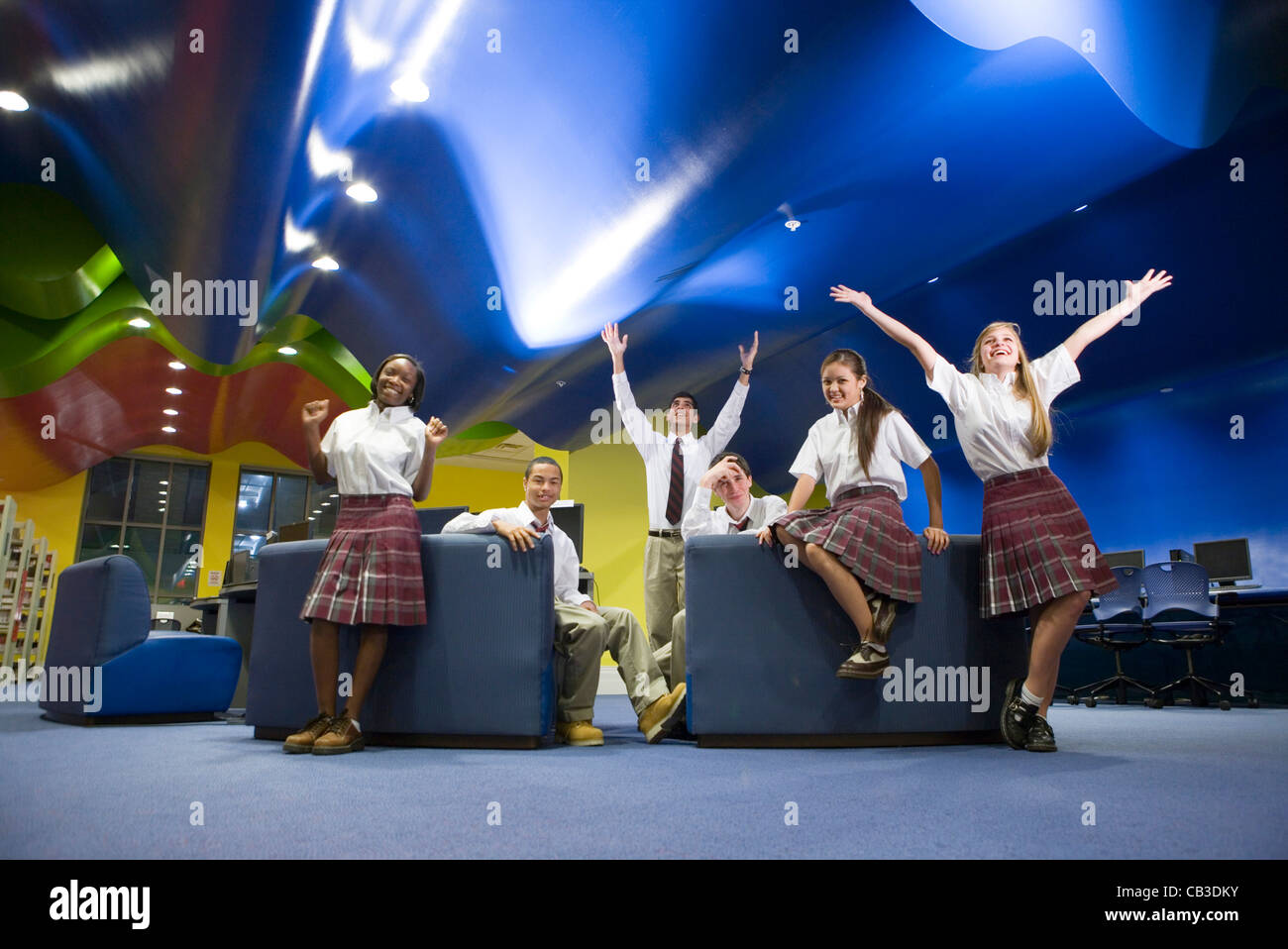 Group of teenage students hanging out in lounge area of library Stock ...