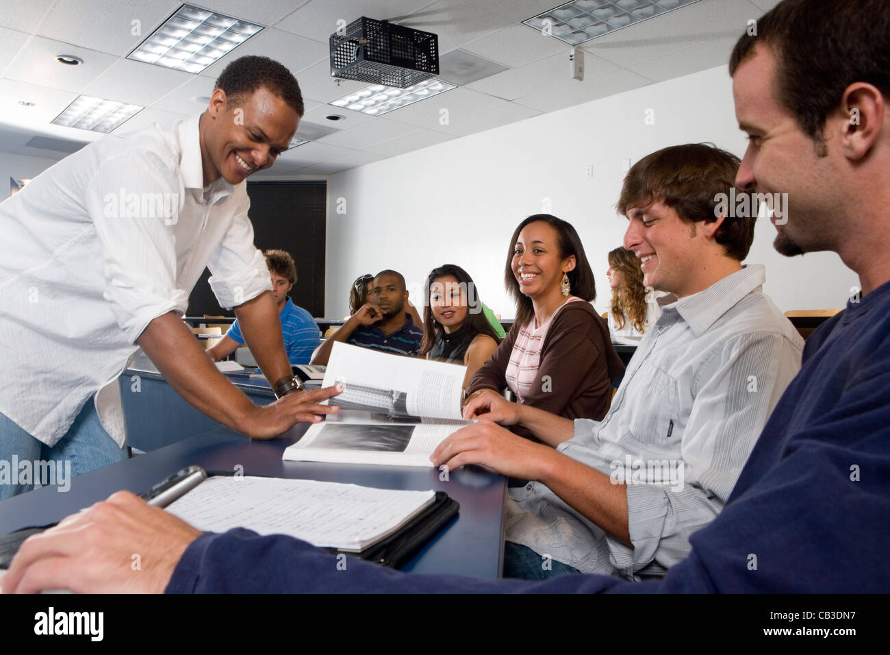 Teacher teaching students in the classroom Stock Photo - Alamy
