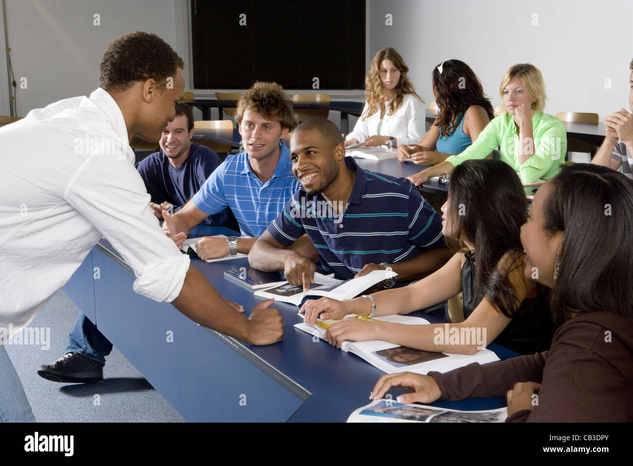 Teacher teaching students in the classroom Stock Photo - Alamy