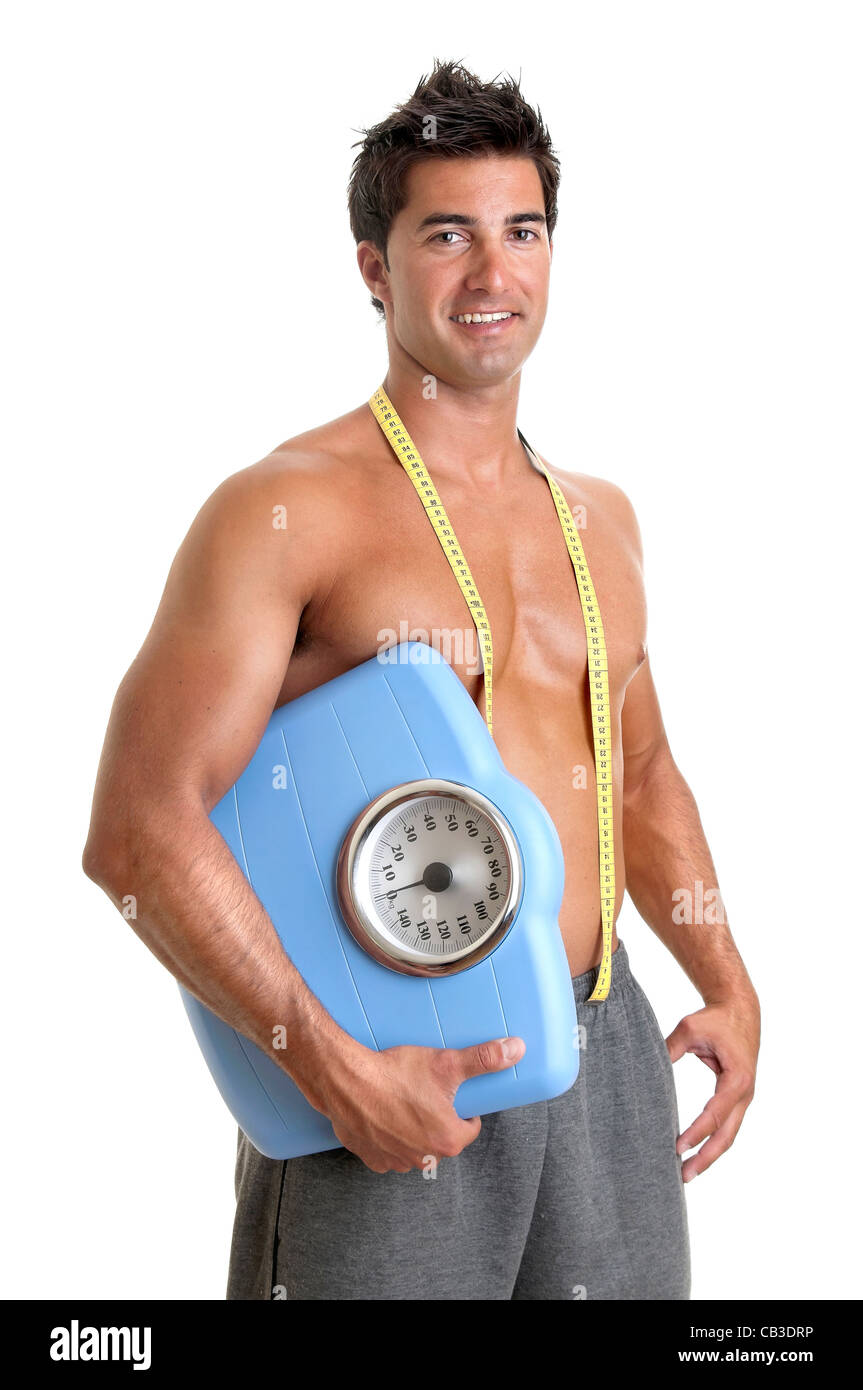 Muscular young man with weight scale Stock Photo - Alamy