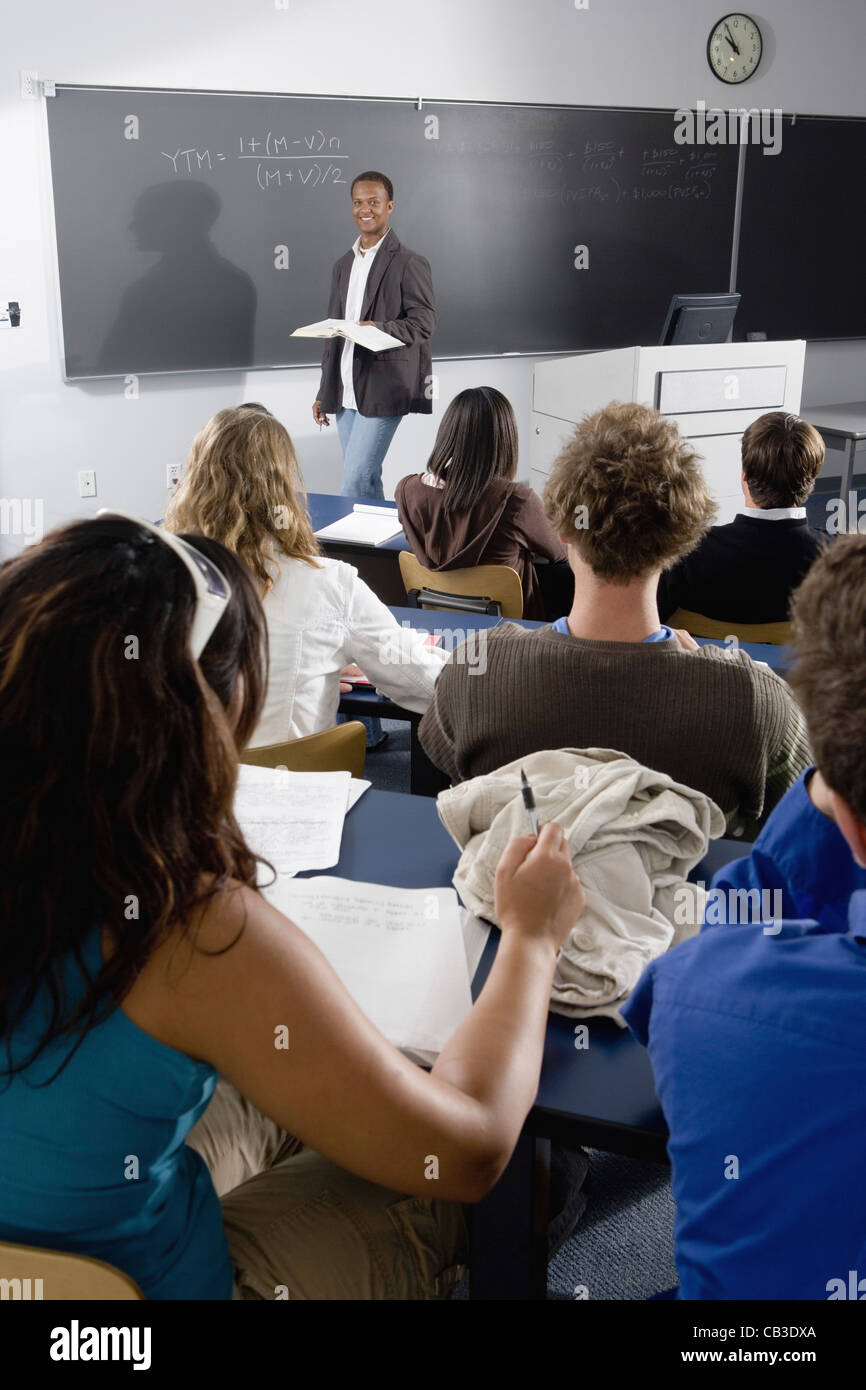 Teacher teaching students in the classroom Stock Photo - Alamy