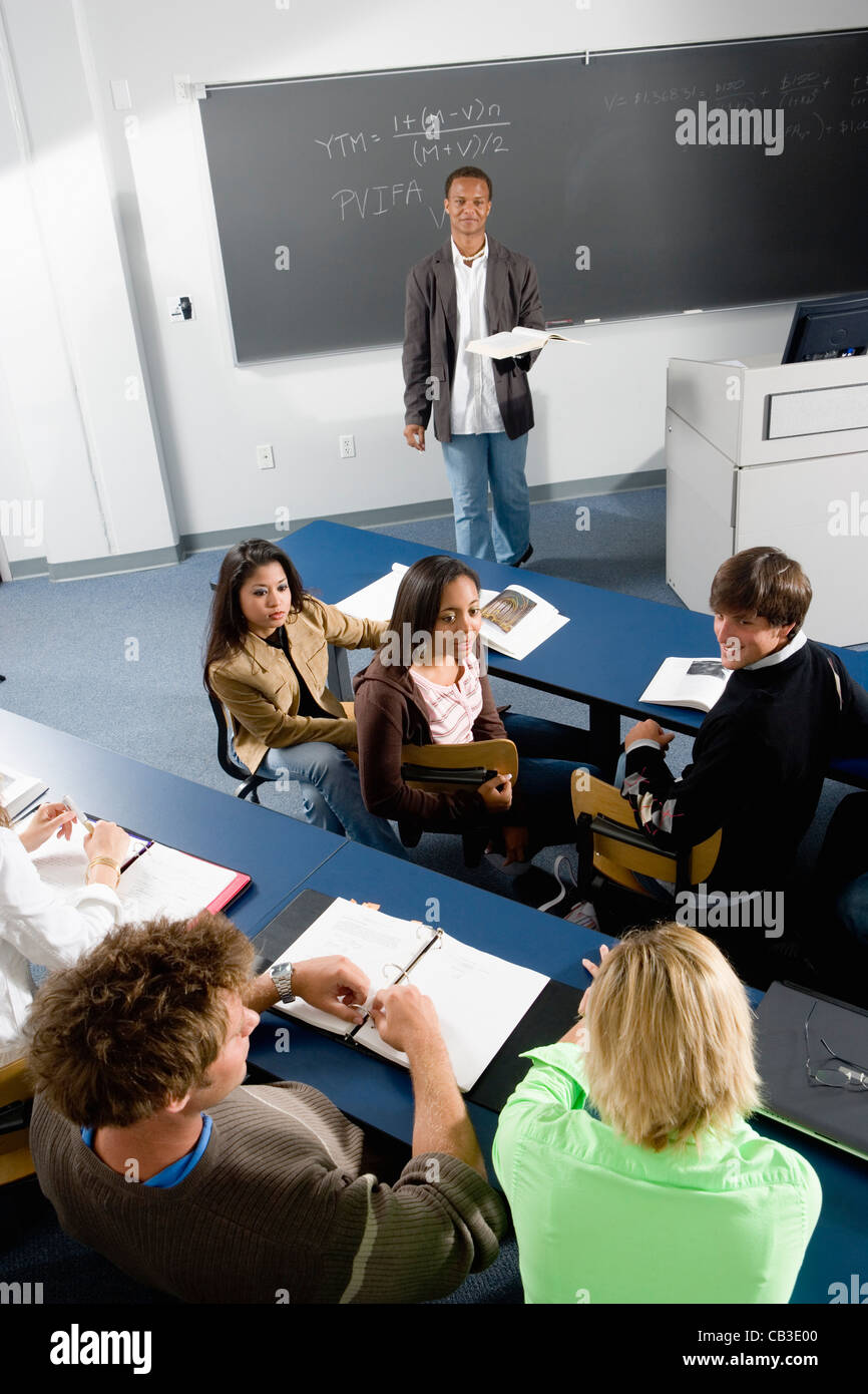 Teacher teaching students in the classroom Stock Photo - Alamy