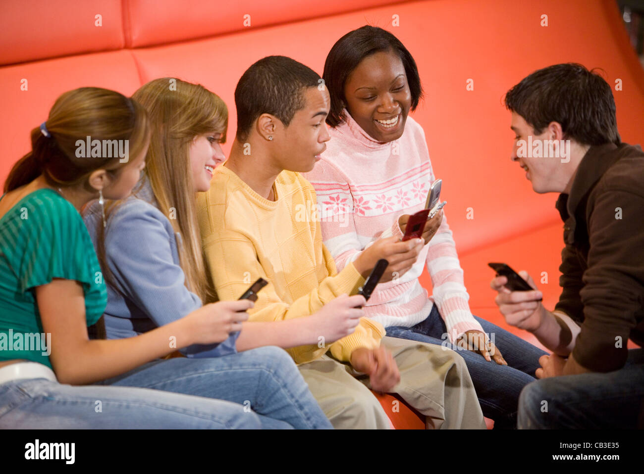 Group friends cellphones african hi-res stock photography and images ...