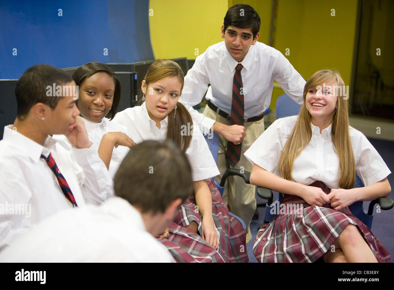 Group of high school students in uniforms conversing Stock Photo - Alamy