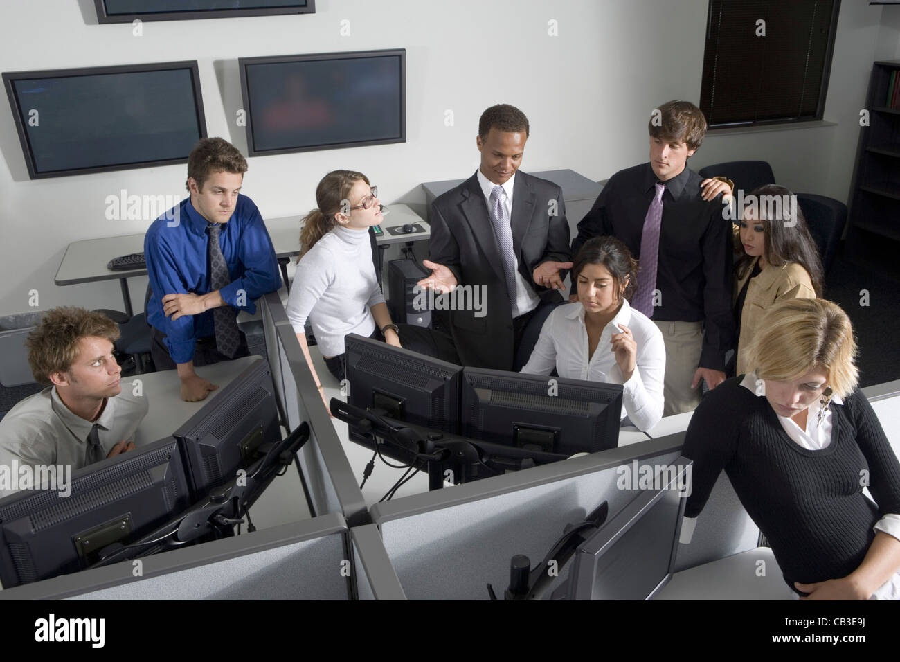 Group of young workers in office working on computers Stock Photo - Alamy