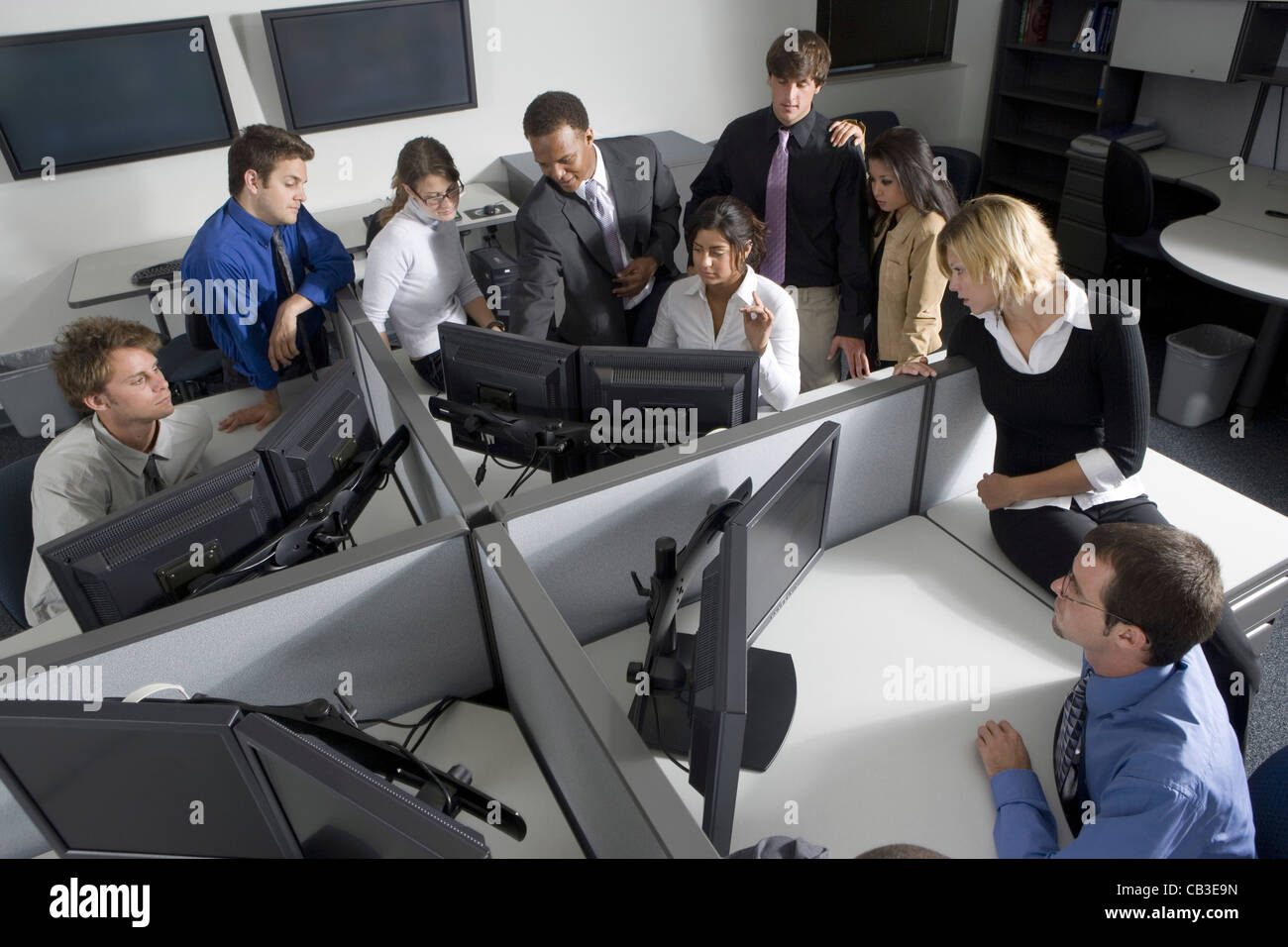 Group of young workers in office working on computers Stock Photo - Alamy