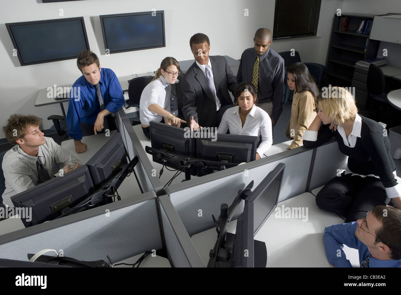 Group of young workers in office working on computers Stock Photo - Alamy
