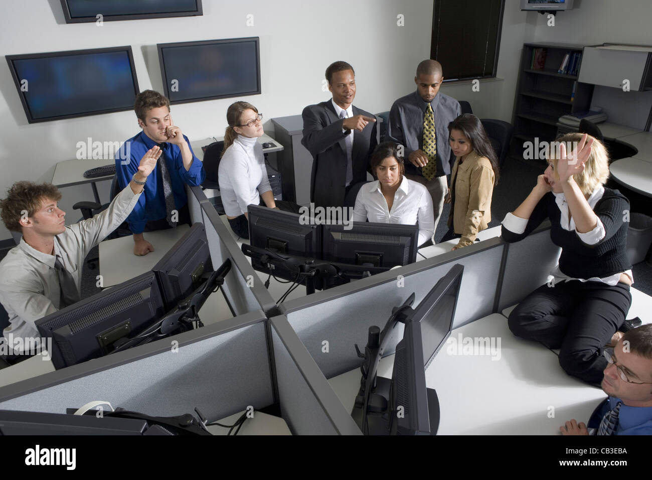 Group of young workers in office working on computers Stock Photo - Alamy