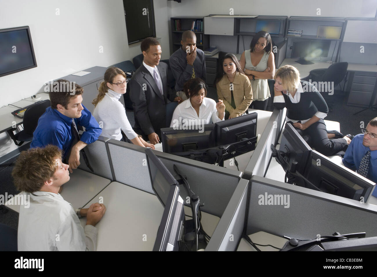 Group of young workers in office working on computers Stock Photo - Alamy