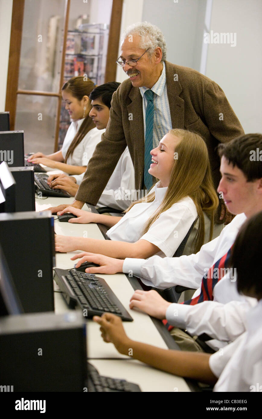 Group of high school students with their teacher in a computer lab ...