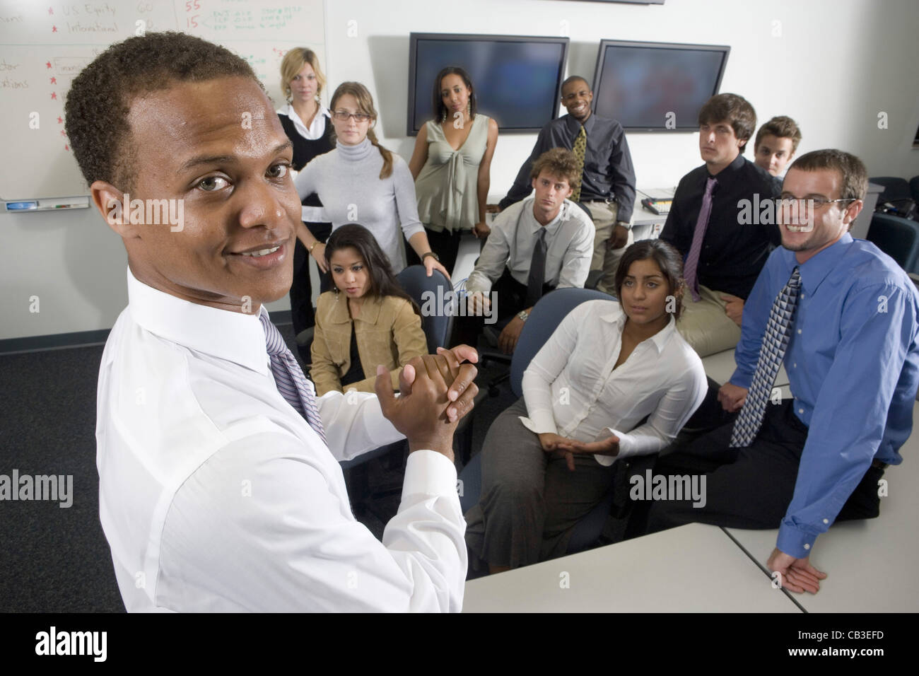 Group of young workers in office gathered for a meeting Stock Photo - Alamy