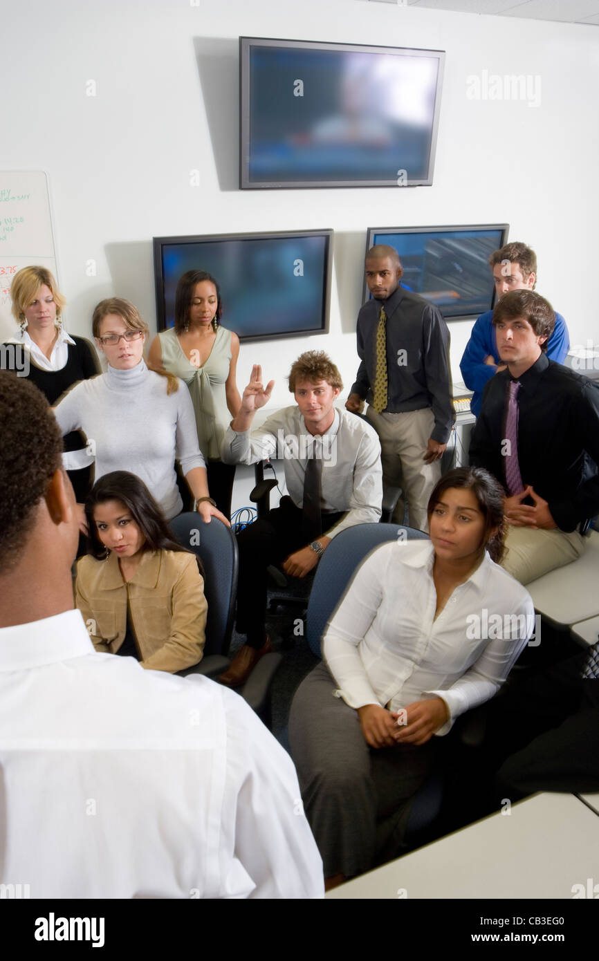 Group of young workers in office gathered for a meeting Stock Photo - Alamy