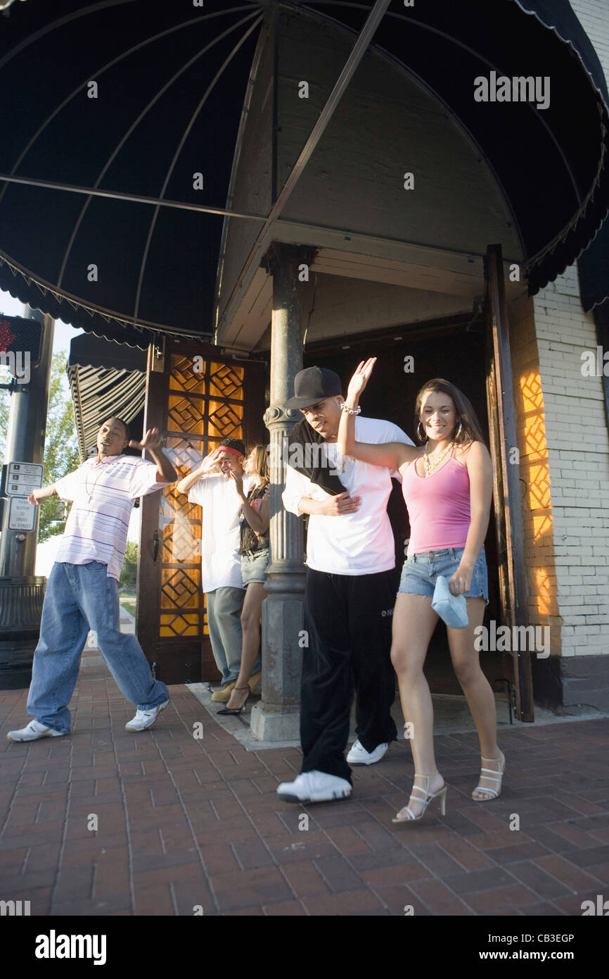 Young men and women leaving a bar at sunrise Stock Photo - Alamy