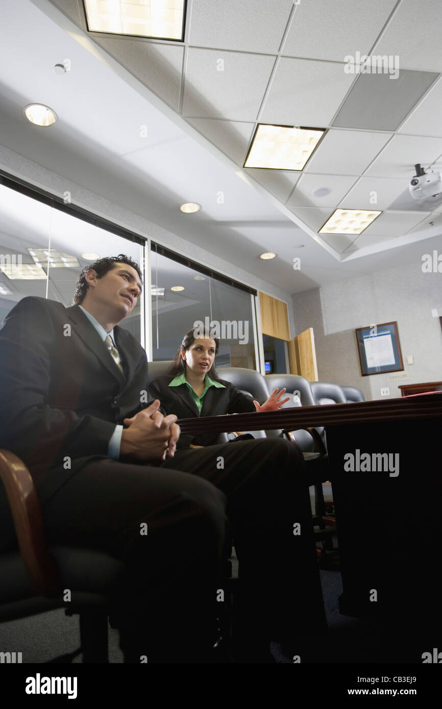 Low angle view of business man and woman meeting in a formal conference ...