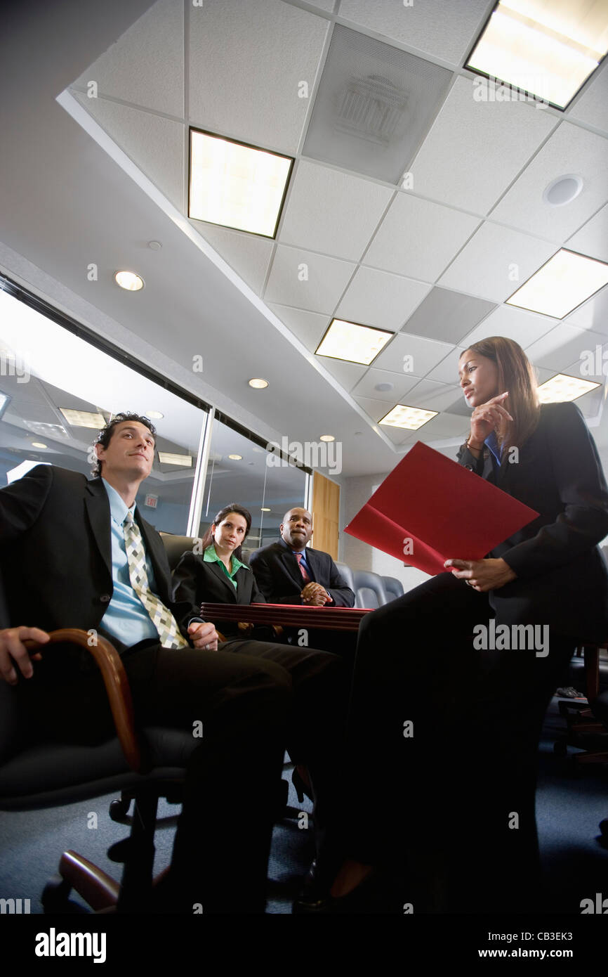 Low angle view of business men and women at a presentation in a formal ...