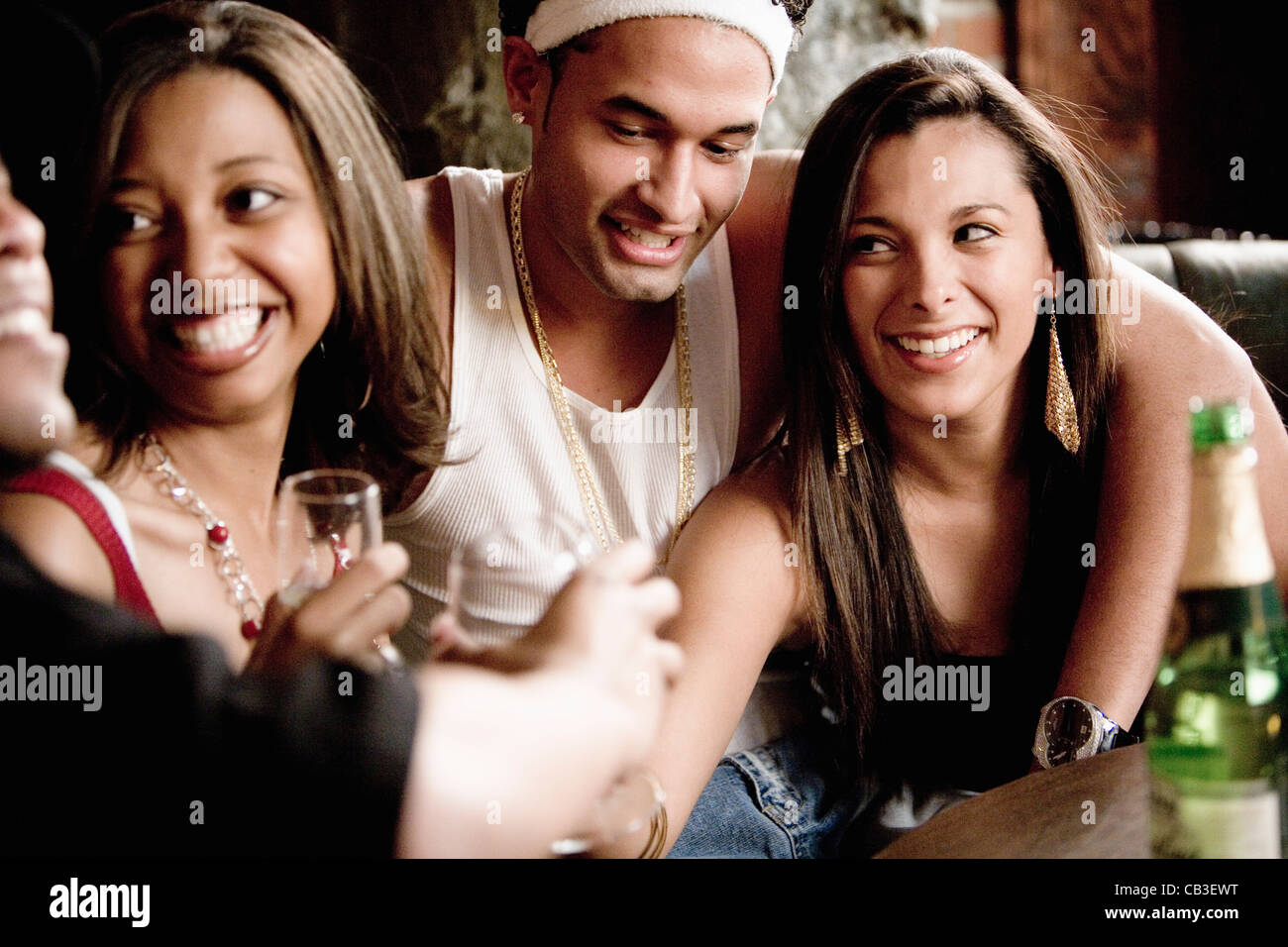 Close-up of group of young friends socializing Stock Photo - Alamy