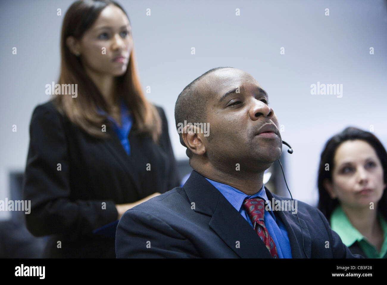 Business man and women watching and listening attentively Stock Photo ...