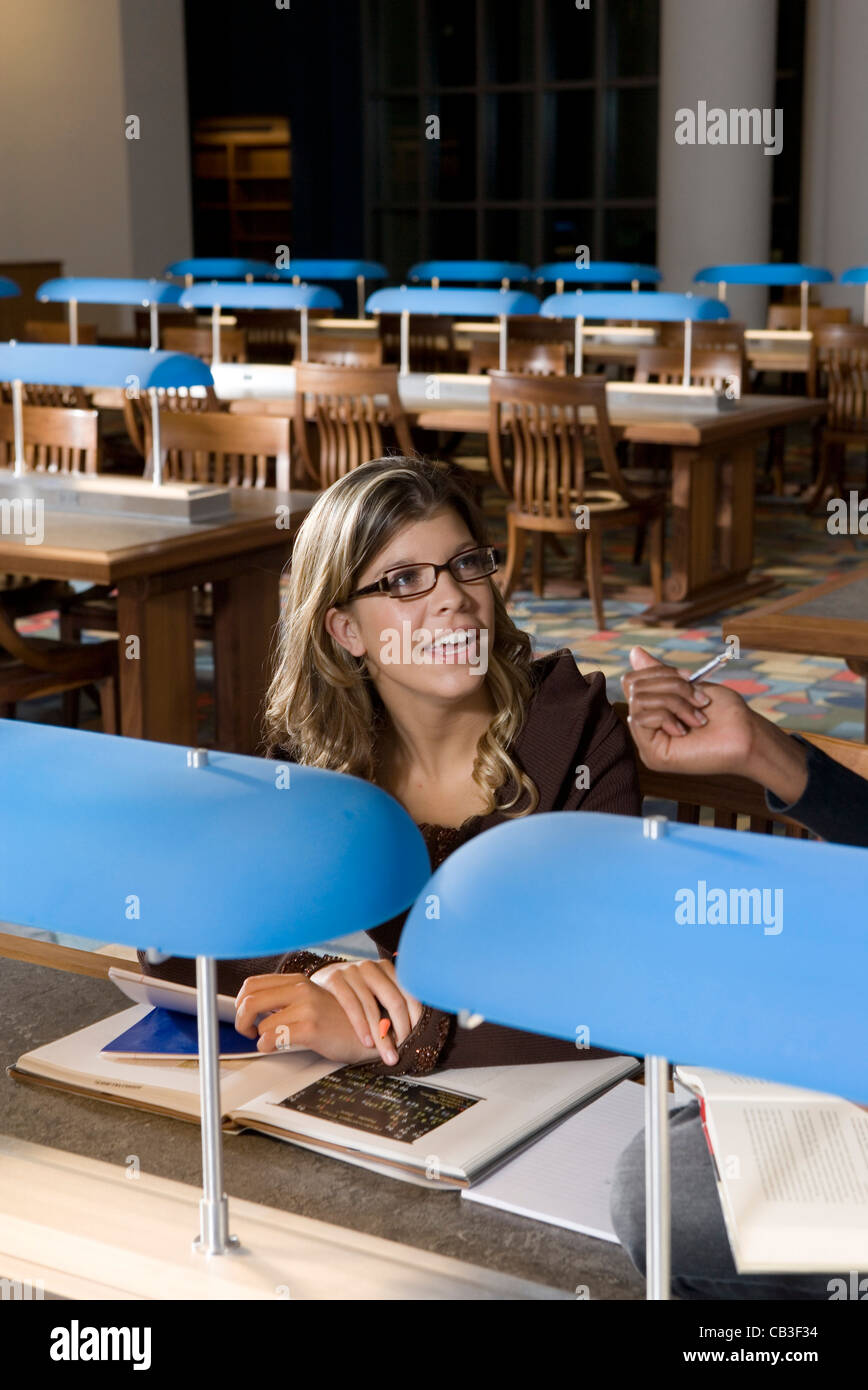 Student sitting in the reading room of a library Stock Photo - Alamy