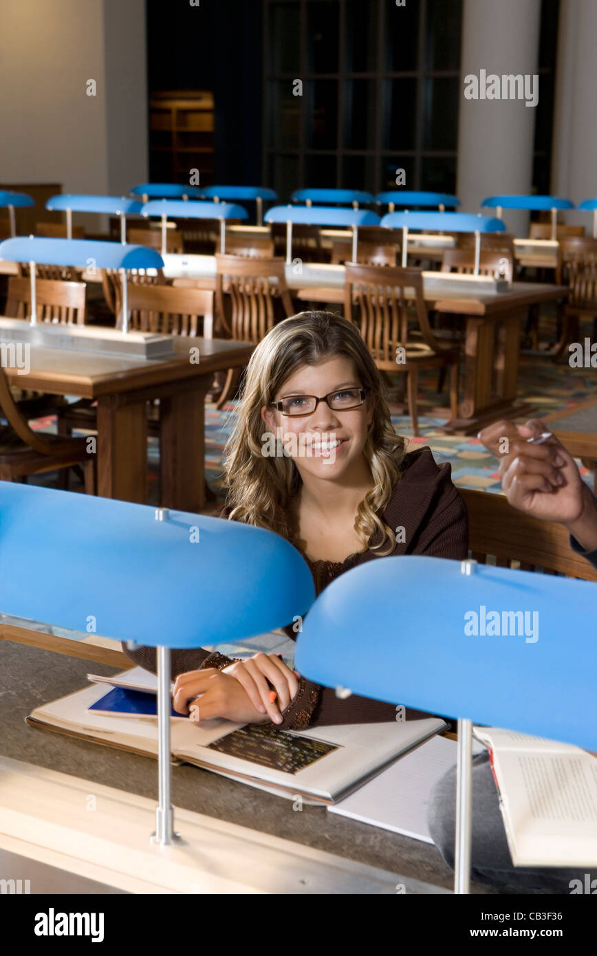 Student sitting in the reading room of a library Stock Photo - Alamy