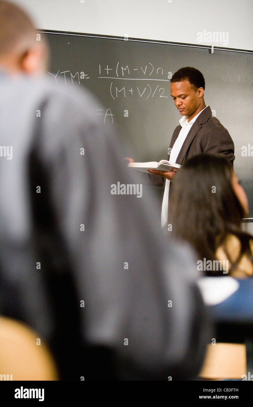 Teacher teaching students in the classroom Stock Photo - Alamy
