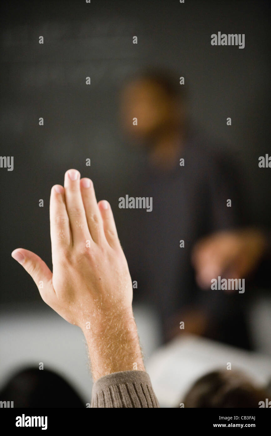Close-up of a raised hand in class Stock Photo - Alamy