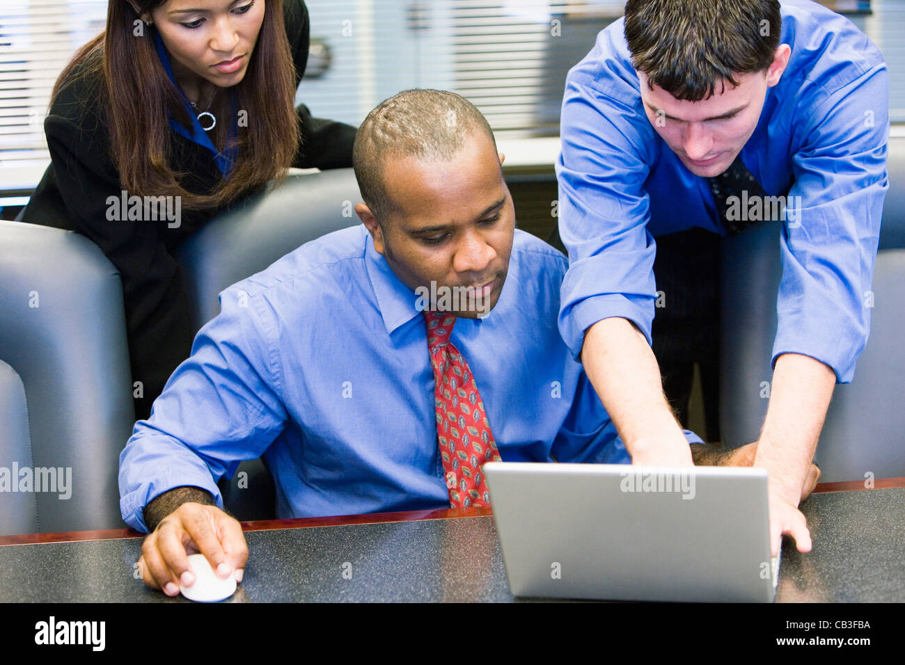 Business colleagues using laptop in a conference room Stock Photo - Alamy