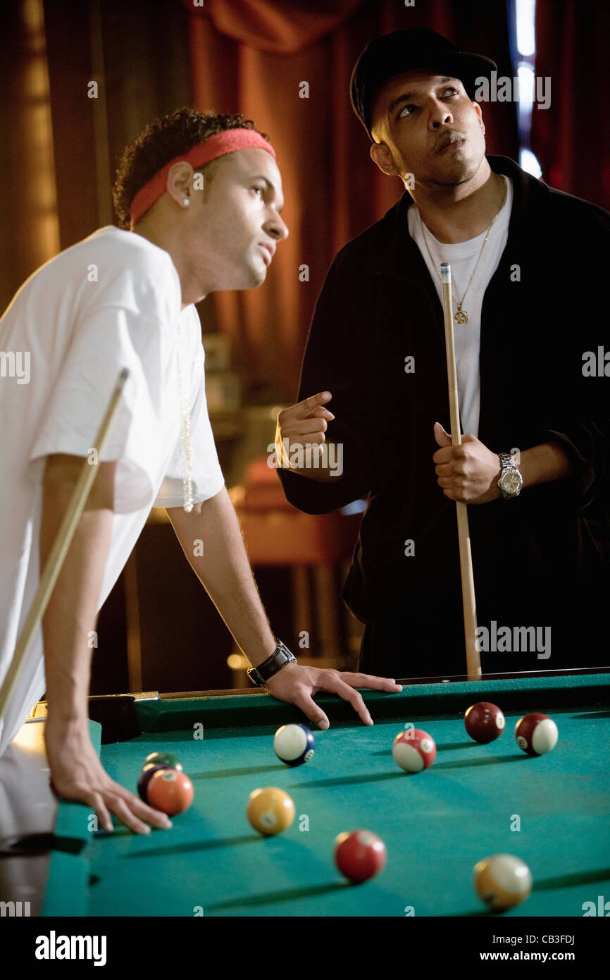 Young men playing billiards in pool hall Stock Photo - Alamy