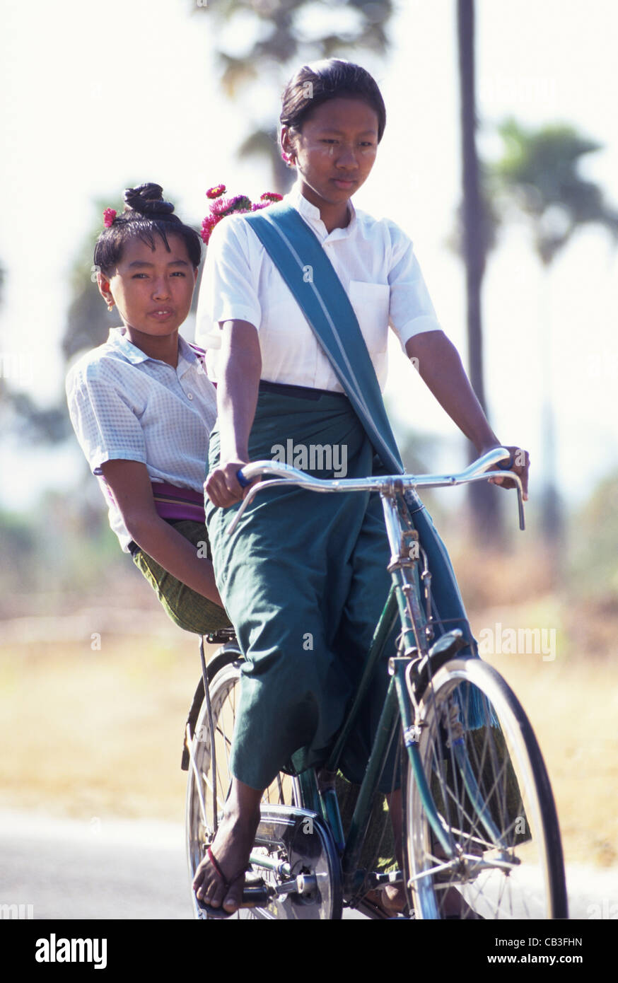 Young female students in uniform on bicycle, Magwe Division, Central ...