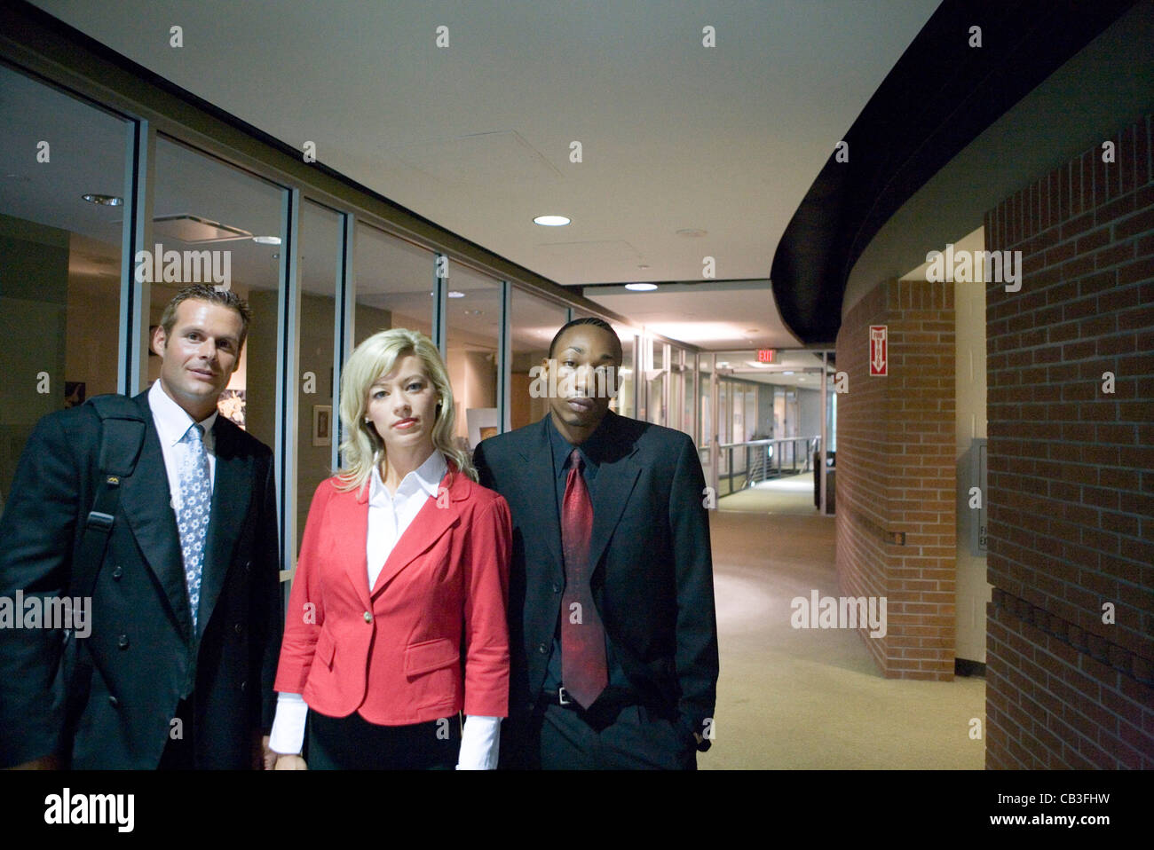 Portrait of business people standing in office hallway Stock Photo - Alamy
